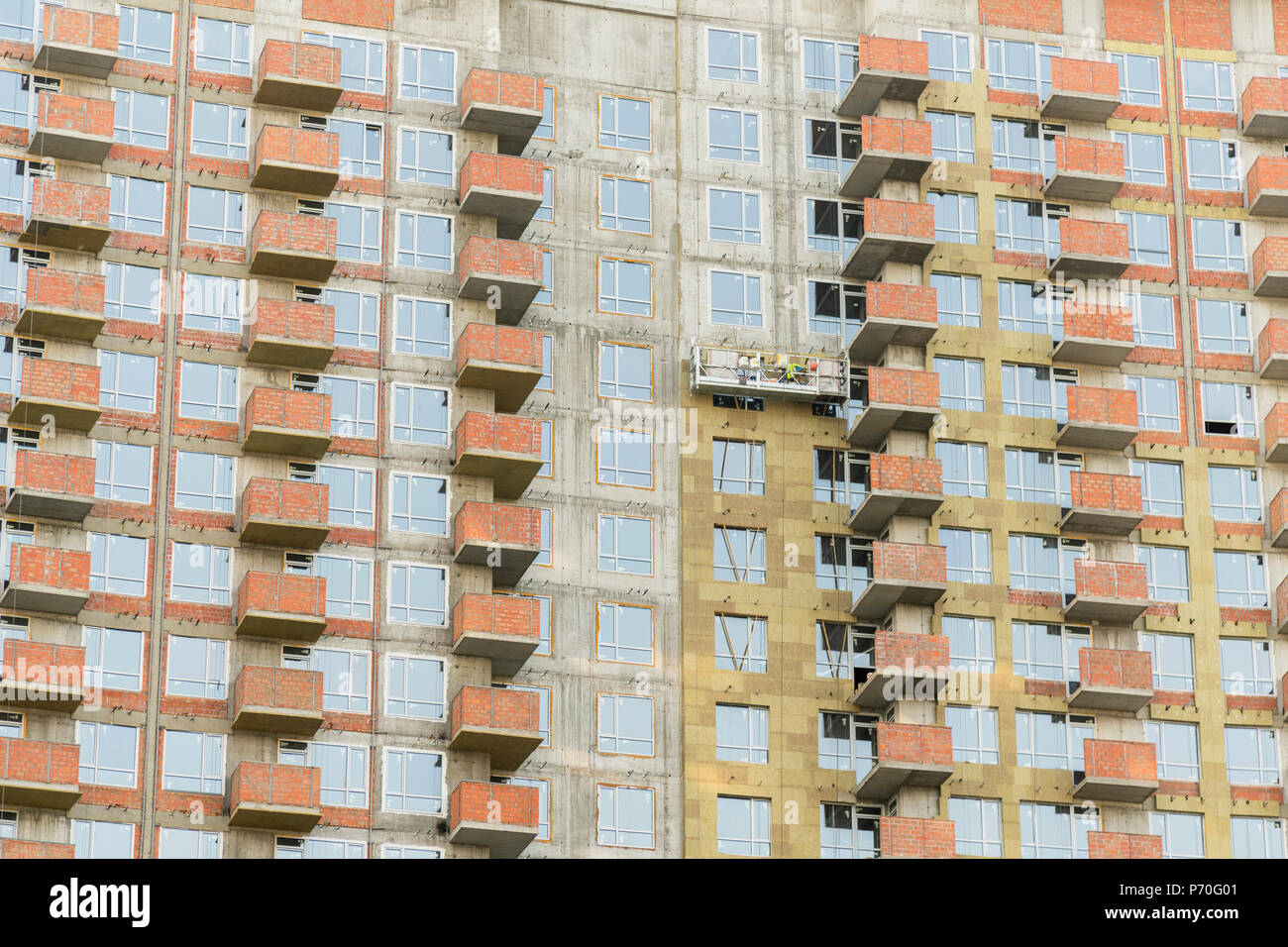 The process of warming a multi-storey building. Workers warm a multi ...
