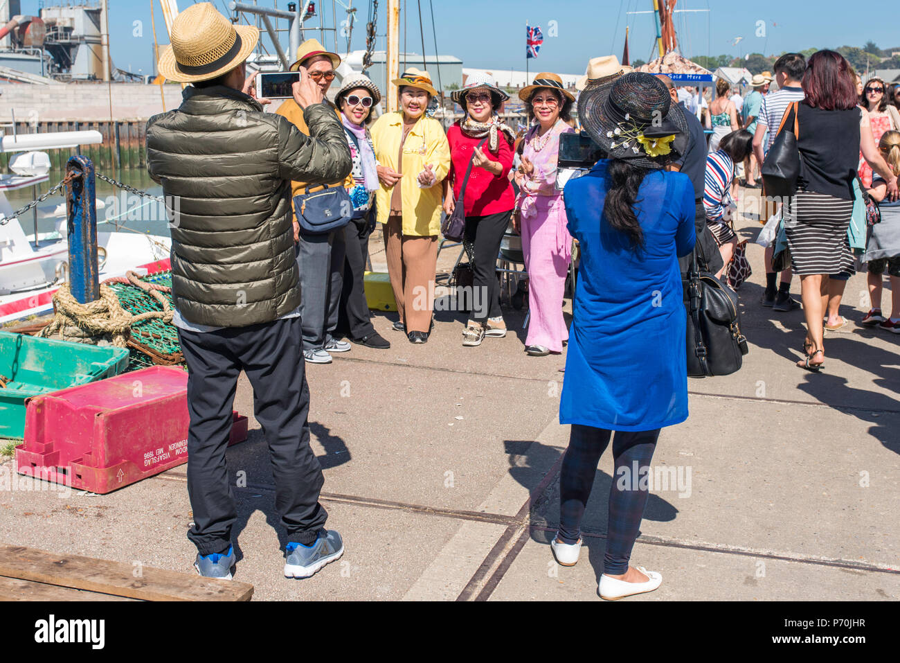 A group of older Chinese tourists posing for a photograph on the ...