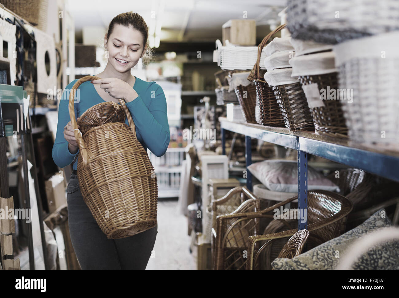Happy cheerful positive smiling woman consumer holding wicker barrel in ...