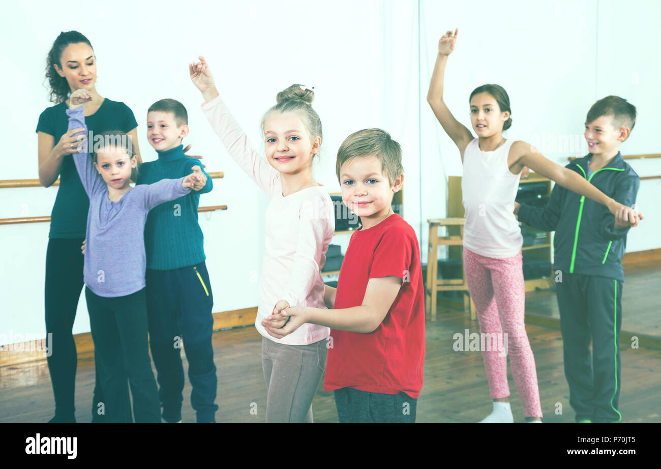 Group of positive children dancing tango in dance studio together Stock ...