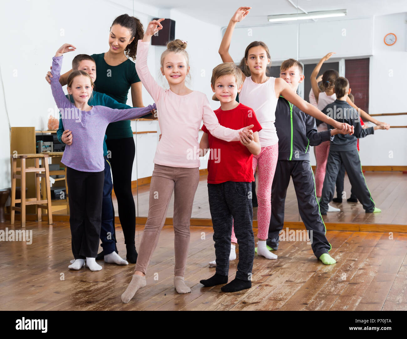 studious little boys and girls dancing pair dance in the ballet studio ...