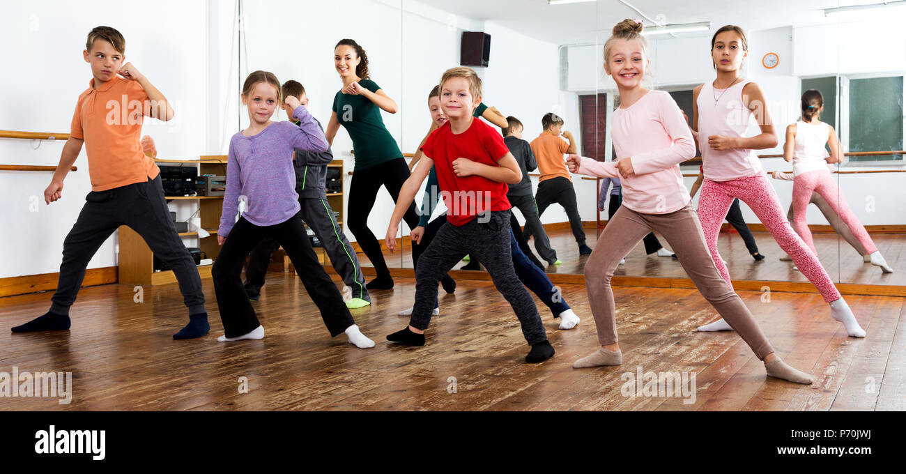 Smiling little children studying modern style dance in class Stock ...