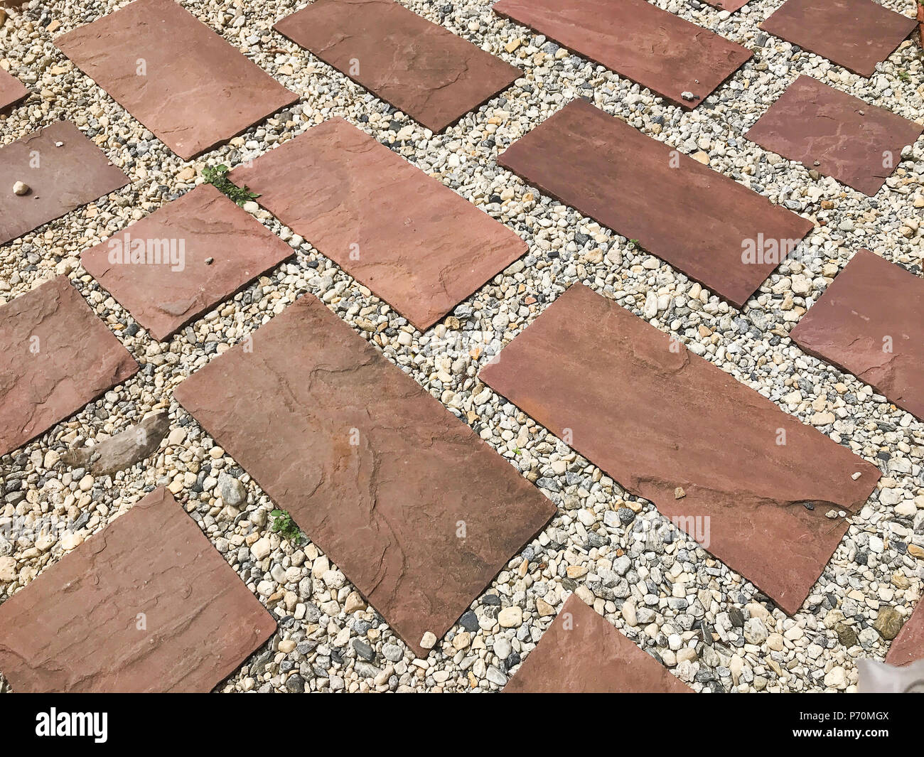 Red brick block ground in perspective Inserted with small stones along ...