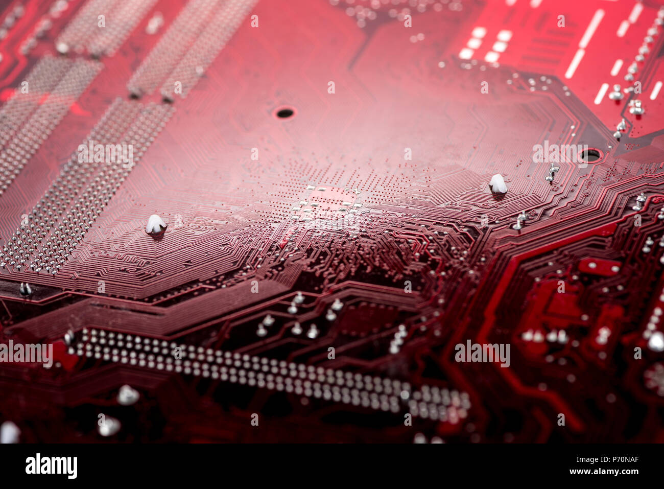 Red computer motherboard with integrated elements Stock Photo - Alamy