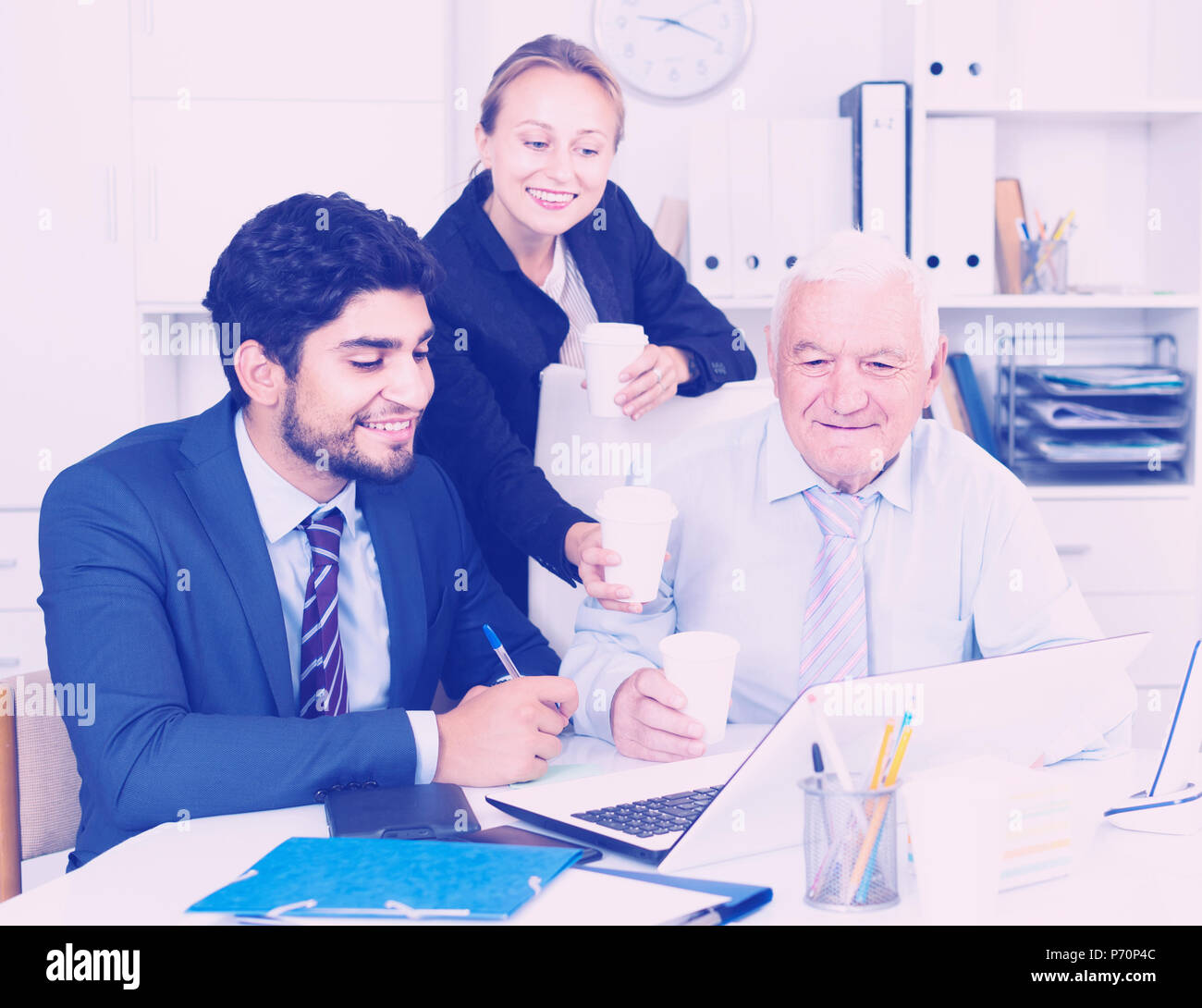 Managers are demonstrating reports on laptop to mature boss in the ...