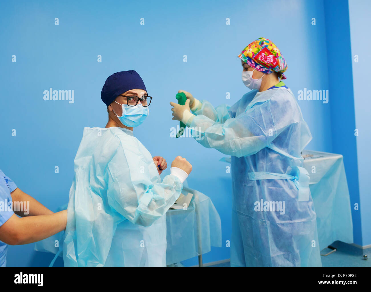 Surgeon dresses before surgery Stock Photo - Alamy