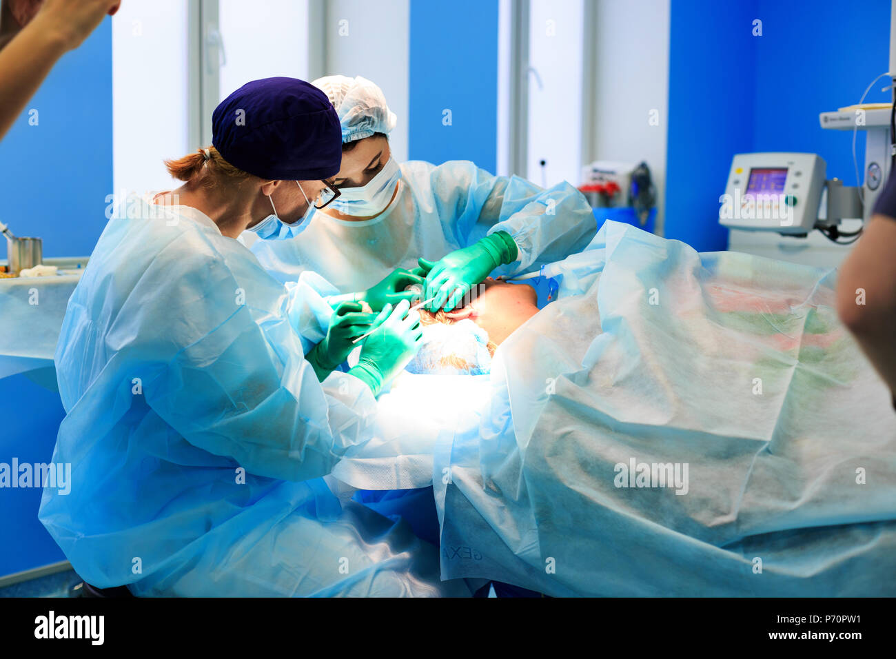 Surgeons operating a patient in operating room Stock Photo - Alamy