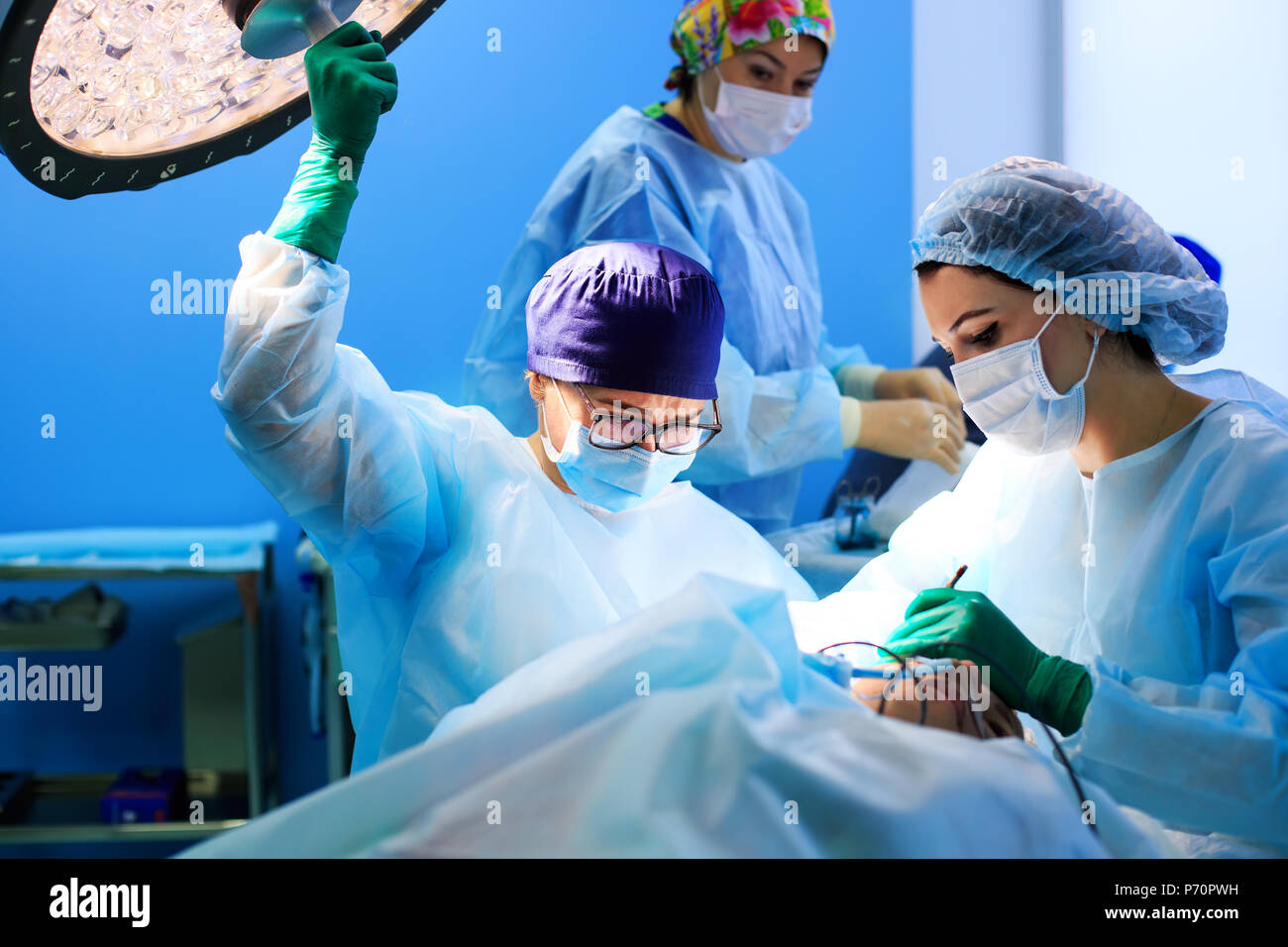 Surgeons operating a patient in operating room Stock Photo - Alamy