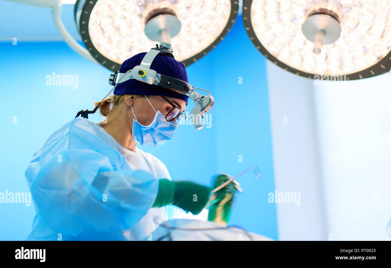 Surgeon operating a patient in operating room Stock Photo - Alamy
