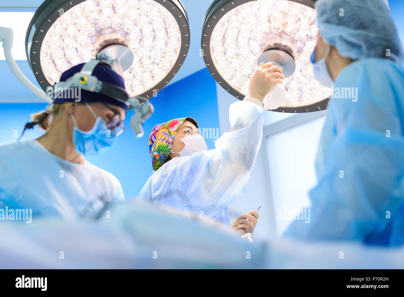 Surgeons operating a patient in operating room Stock Photo - Alamy