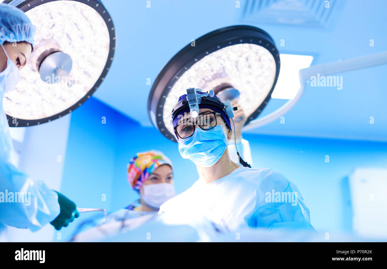 Surgeons operating a patient in operating room Stock Photo - Alamy