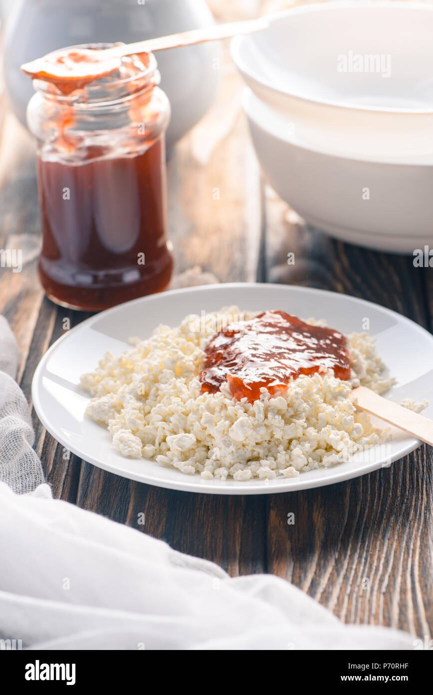 tasty healthy cottage cheese with jam on wooden table Stock Photo - Alamy