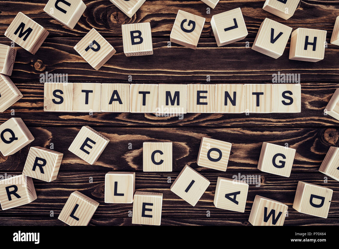 top view of of word statements made of wooden blocks on wooden surface ...