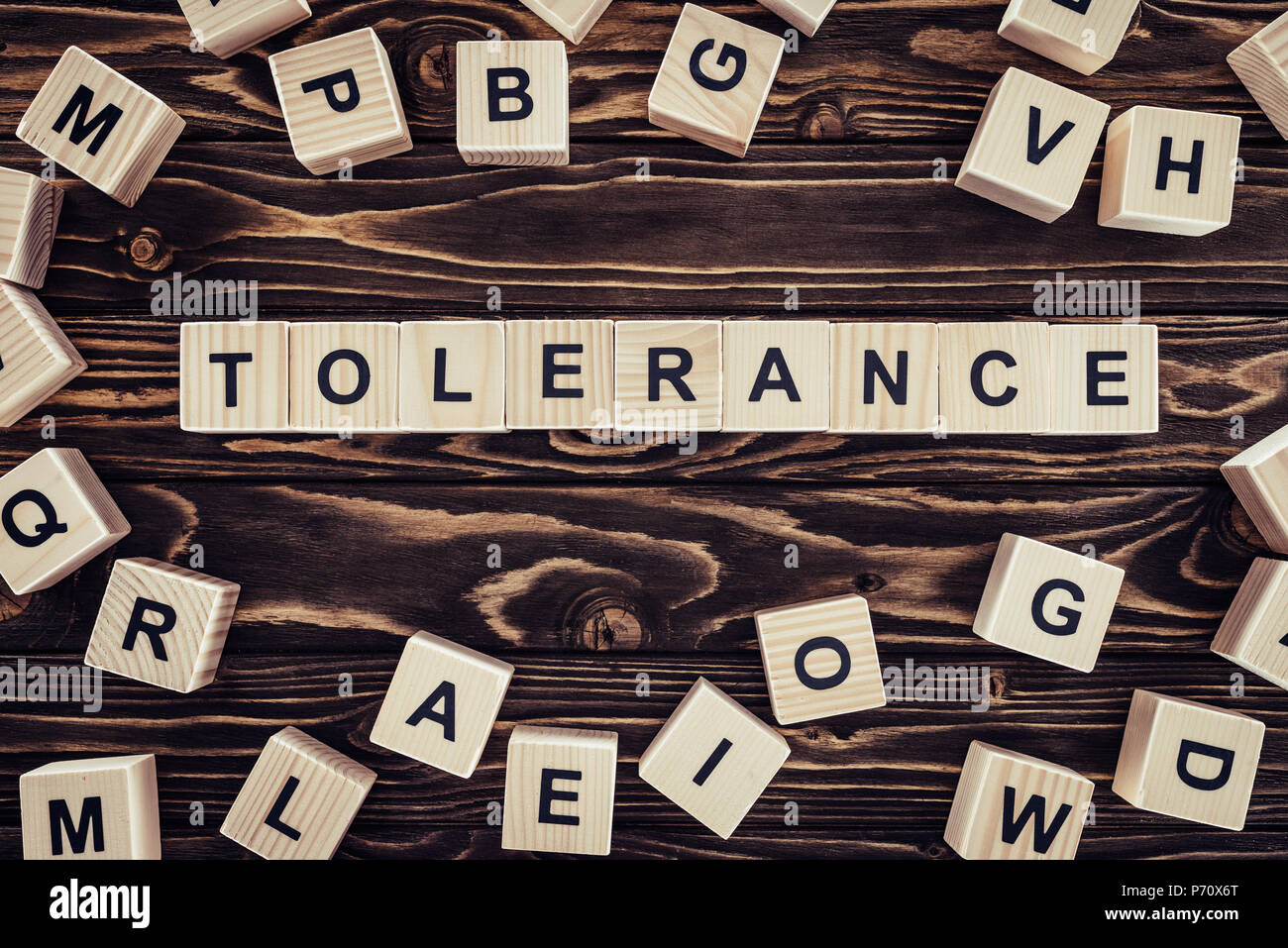 flat lay with arranged wooden blocks in tolerance word on brown wooden ...