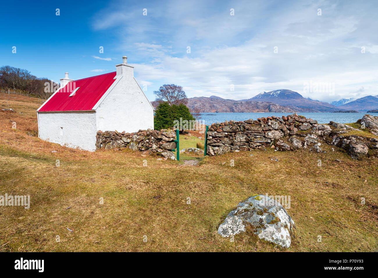 A pretty white cottage with a red tin roof on the shores of Loch ...