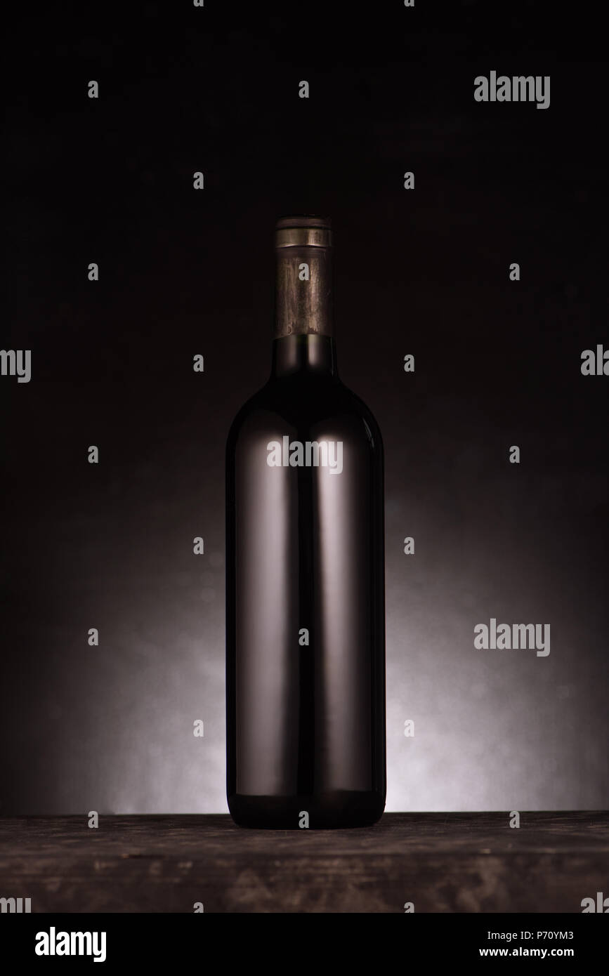 single bottle of luxury red wine on black Stock Photo - Alamy