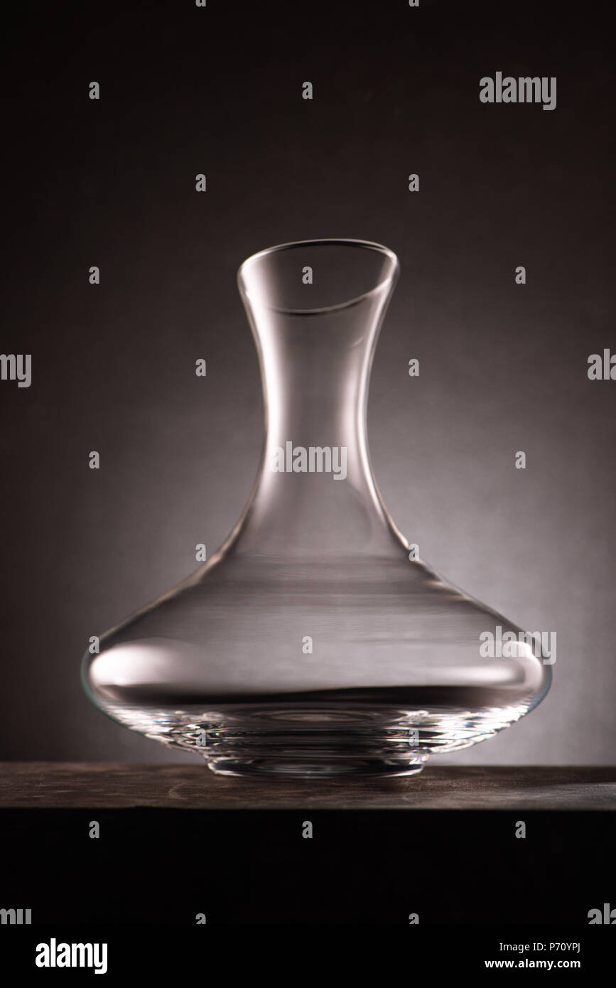 stylish empty decanter for alcohol on black Stock Photo - Alamy