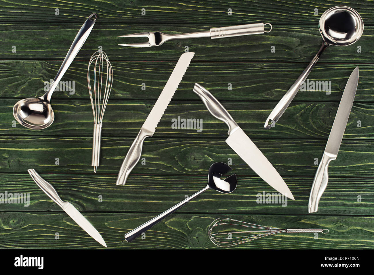 top view of metallic kitchen utensils on wooden table Stock Photo - Alamy