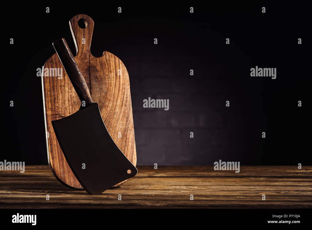 closeup view of wooden cutting board and butcher axe on table Stock ...