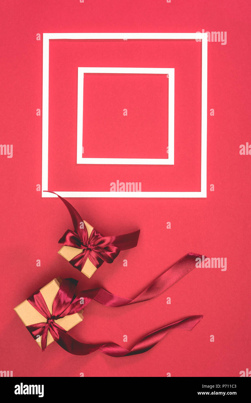 top view of gift boxes and frames on red surface Stock Photo - Alamy