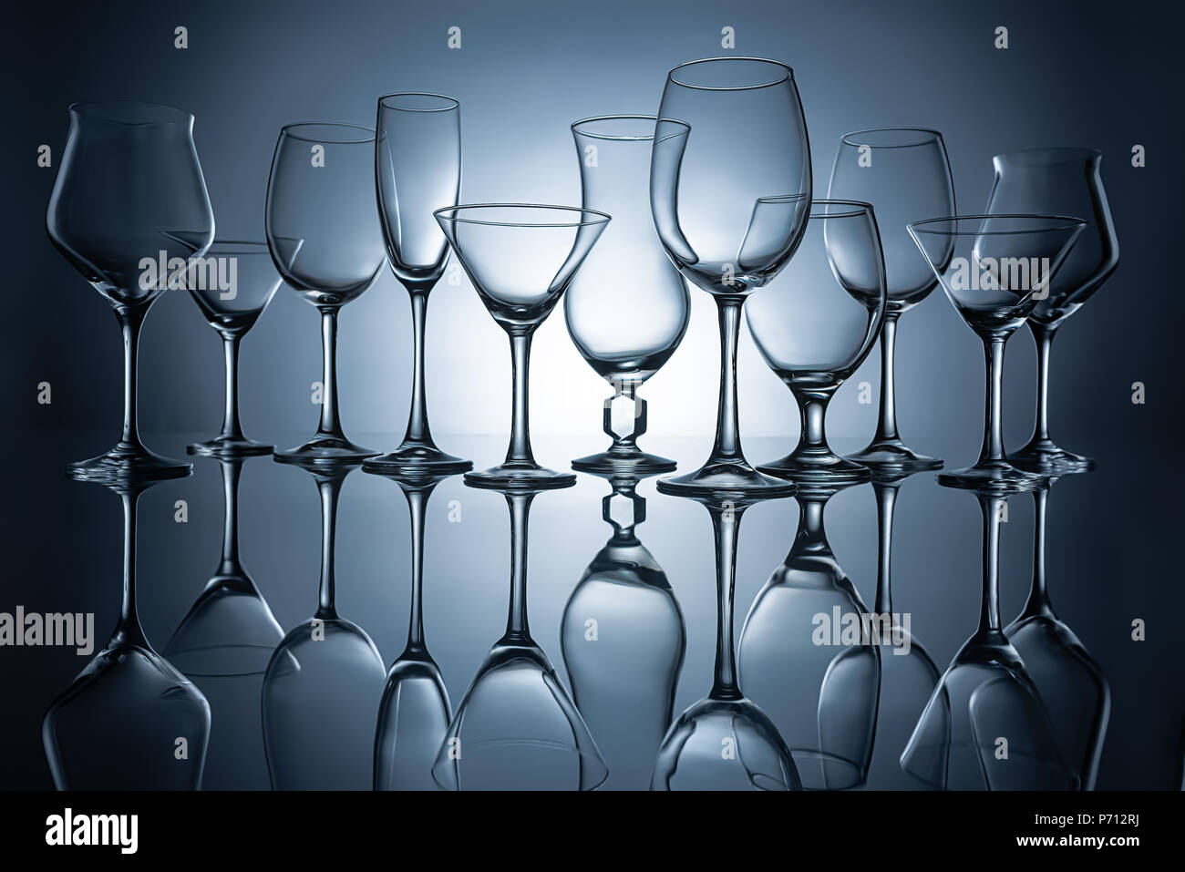 silhouettes of different empty glasses with reflections, on grey Stock ...