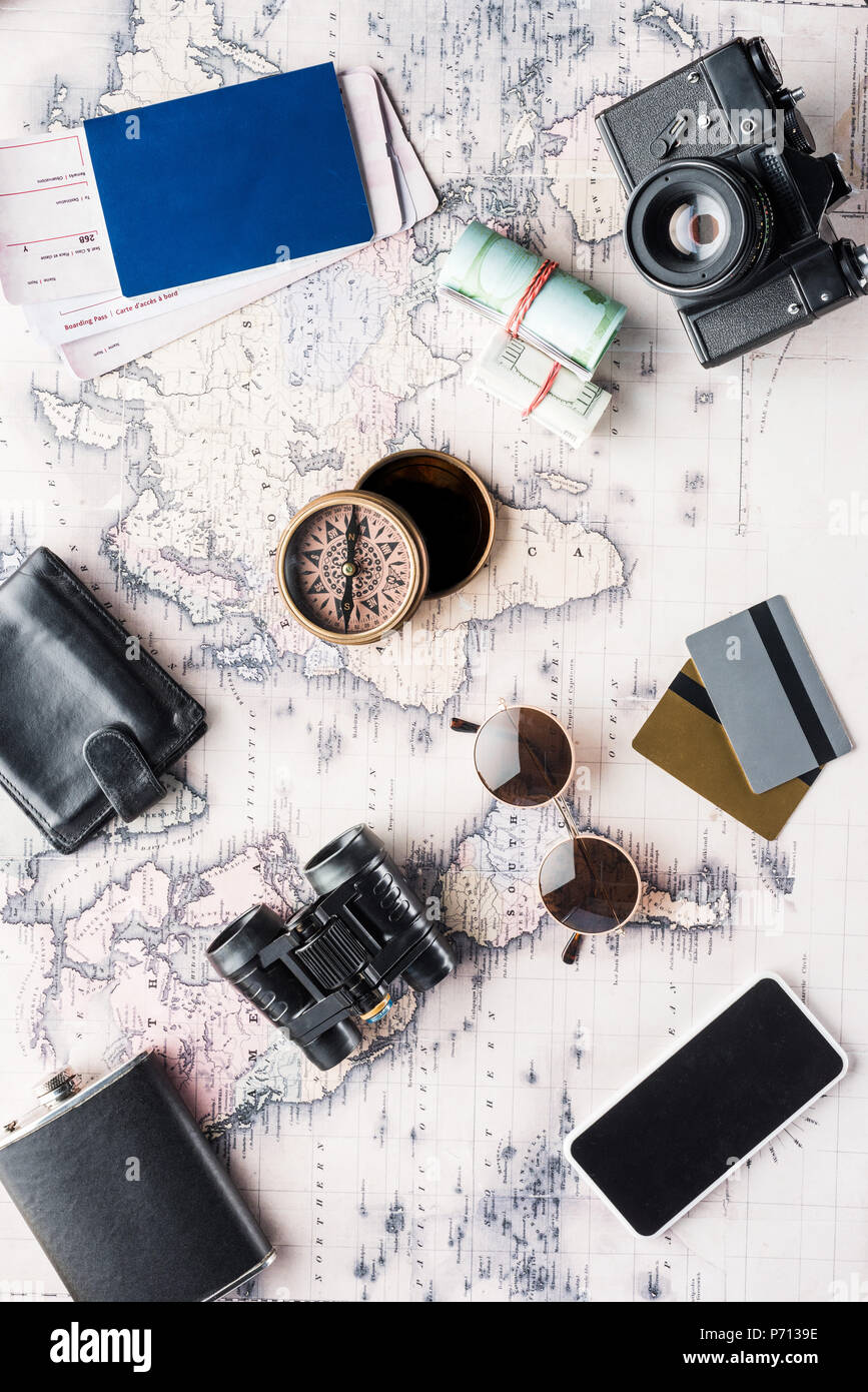 top view of messy variation of travel attributes on map Stock Photo - Alamy