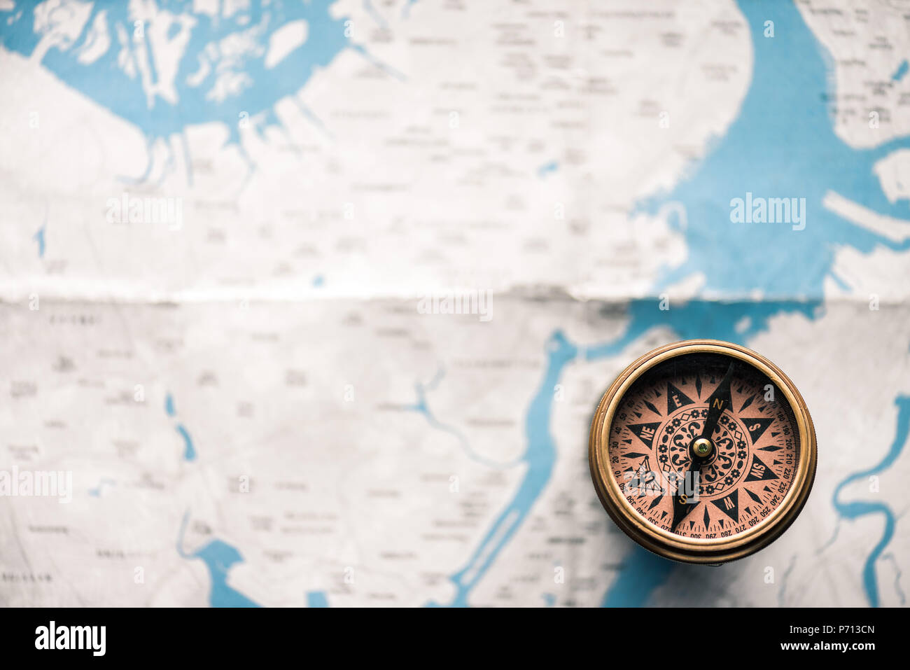 top view of vintage compass on map Stock Photo - Alamy