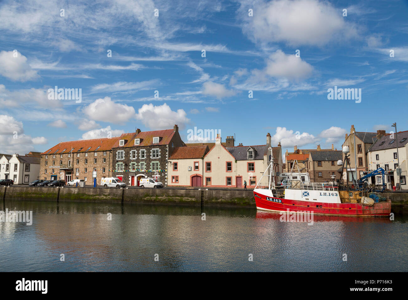 Traditional fishing boat in the sheltered harbour at Eyemouth ...