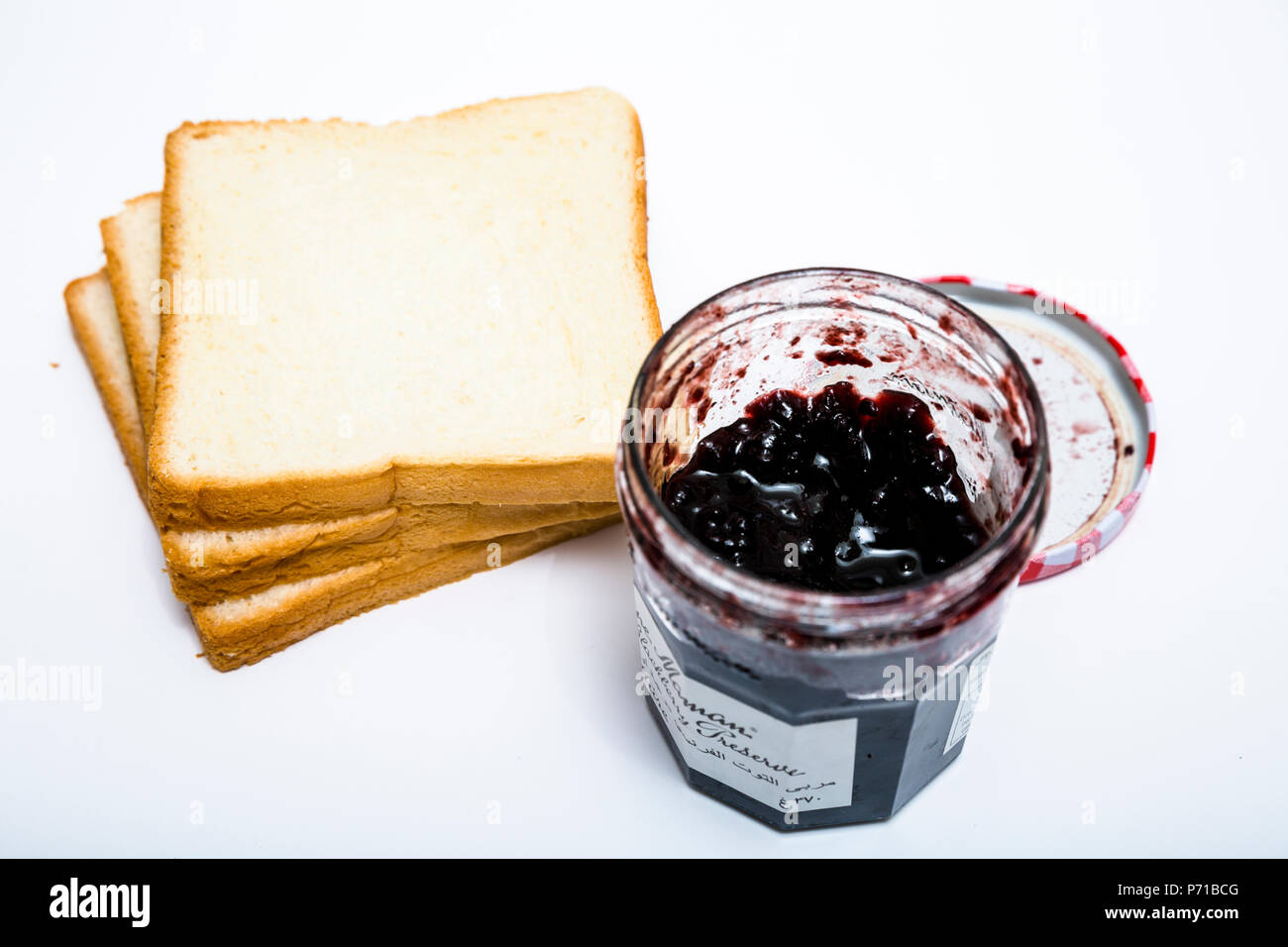 bread slices and jam in white background Stock Photo - Alamy