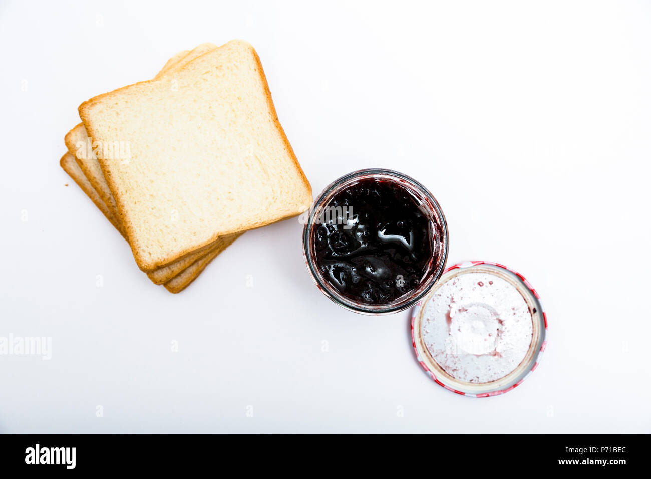 bread slices and jam in white background Stock Photo - Alamy