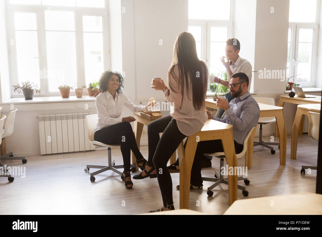 Colleagues having lunch together office hi-res stock photography and ...