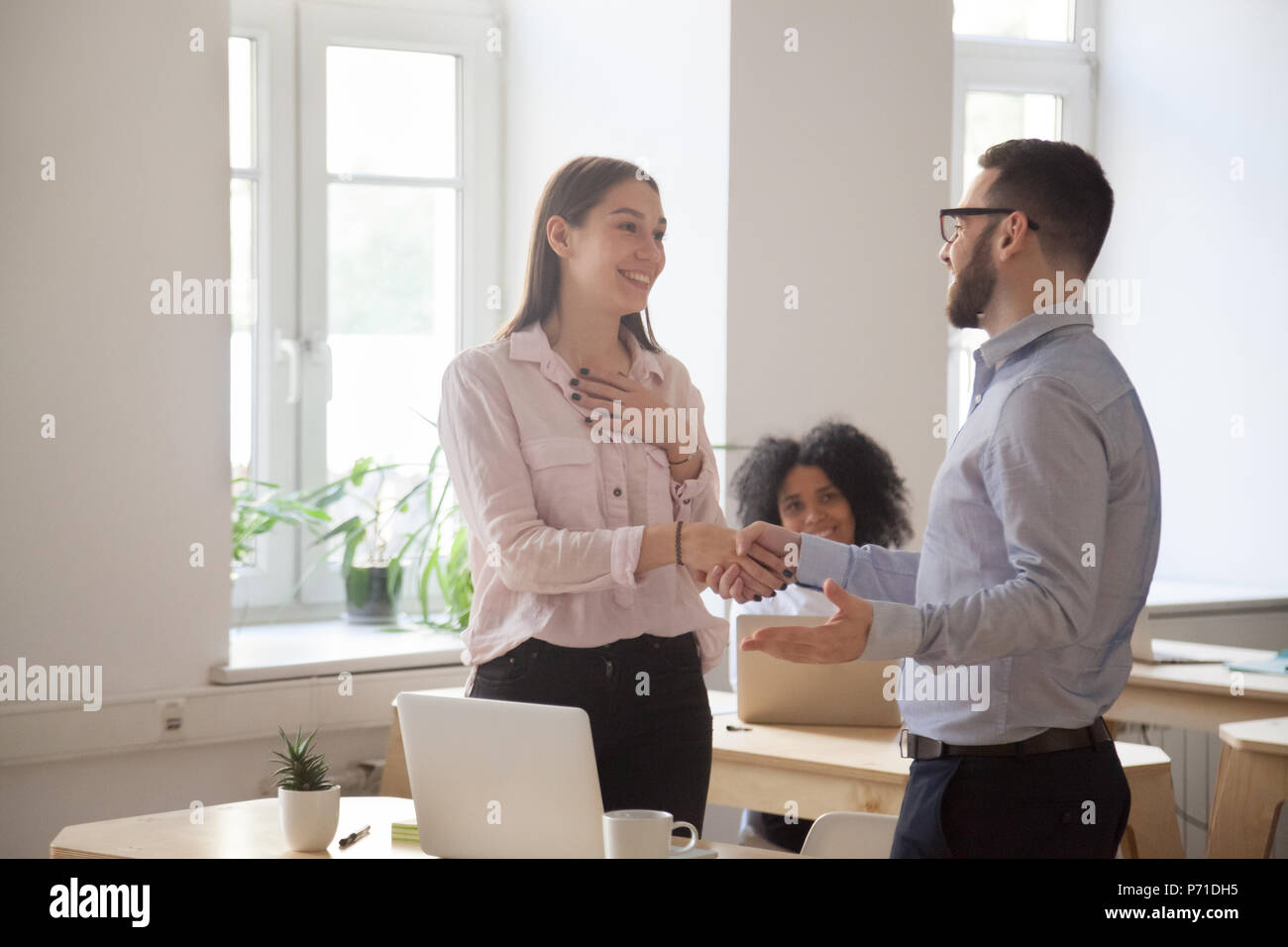 Male boss handshaking employee congratulating with promotion Stock ...