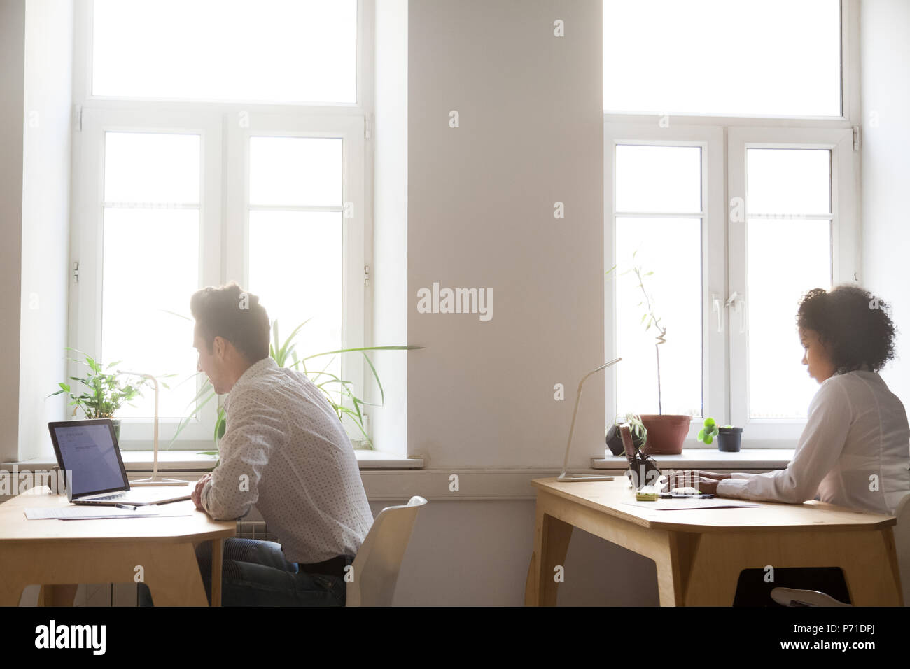 Colleagues in office using laptops hi-res stock photography and images ...
