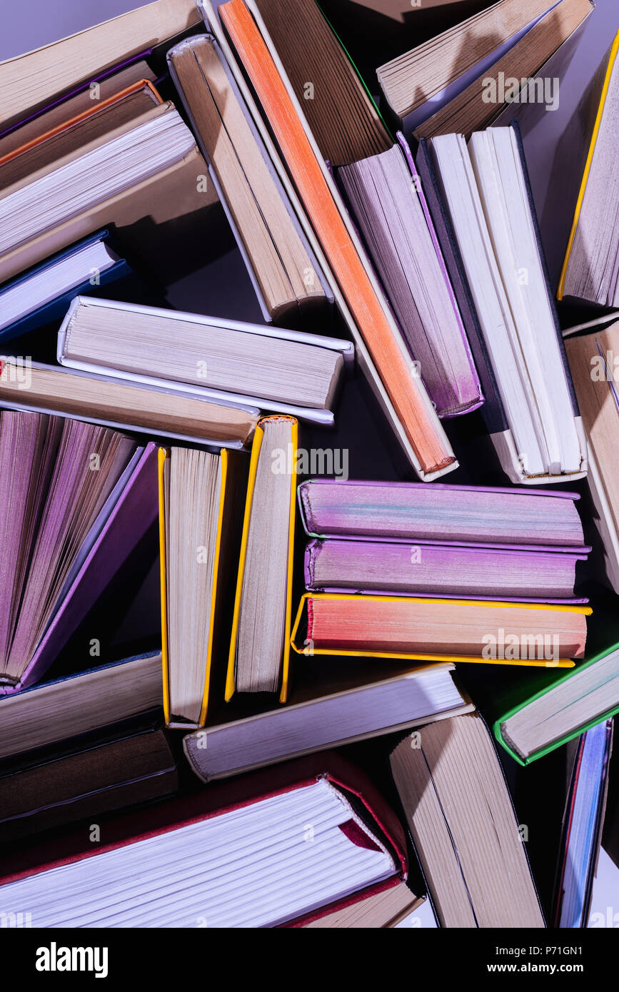 top view of scattered stack of books on table Stock Photo - Alamy