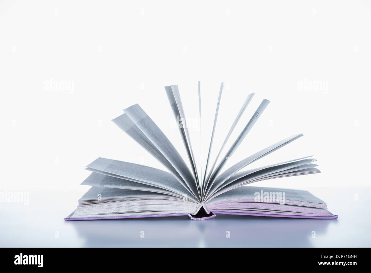 one open book on white surface Stock Photo - Alamy