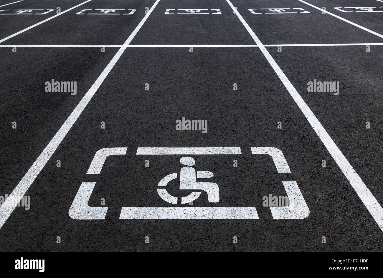 Parking places with handicapped symbol and marking lines on asphalt ...
