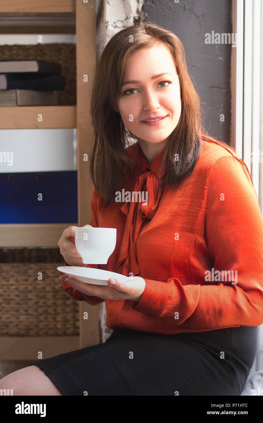 Business lady drinking coffee in office Stock Photo - Alamy
