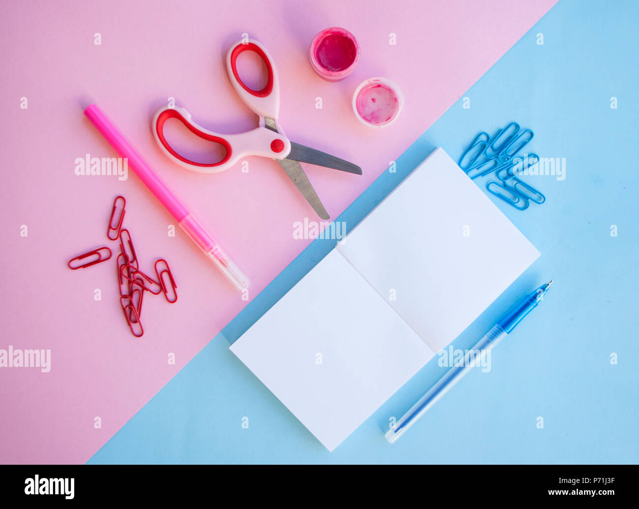 Back to school concept. School supplies on pink and blue background ...