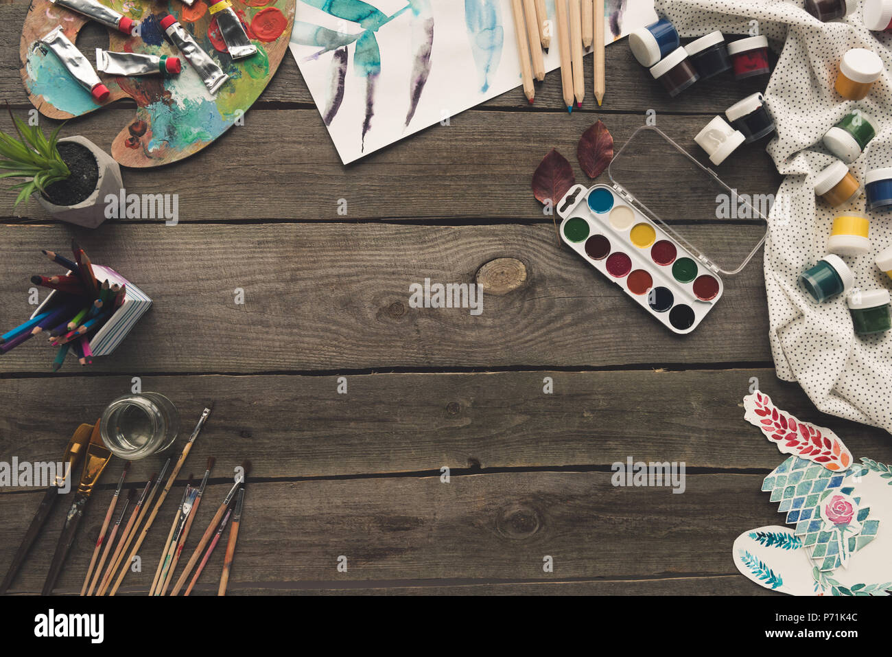 Top view of wooden table with paints and sketches Stock Photo - Alamy