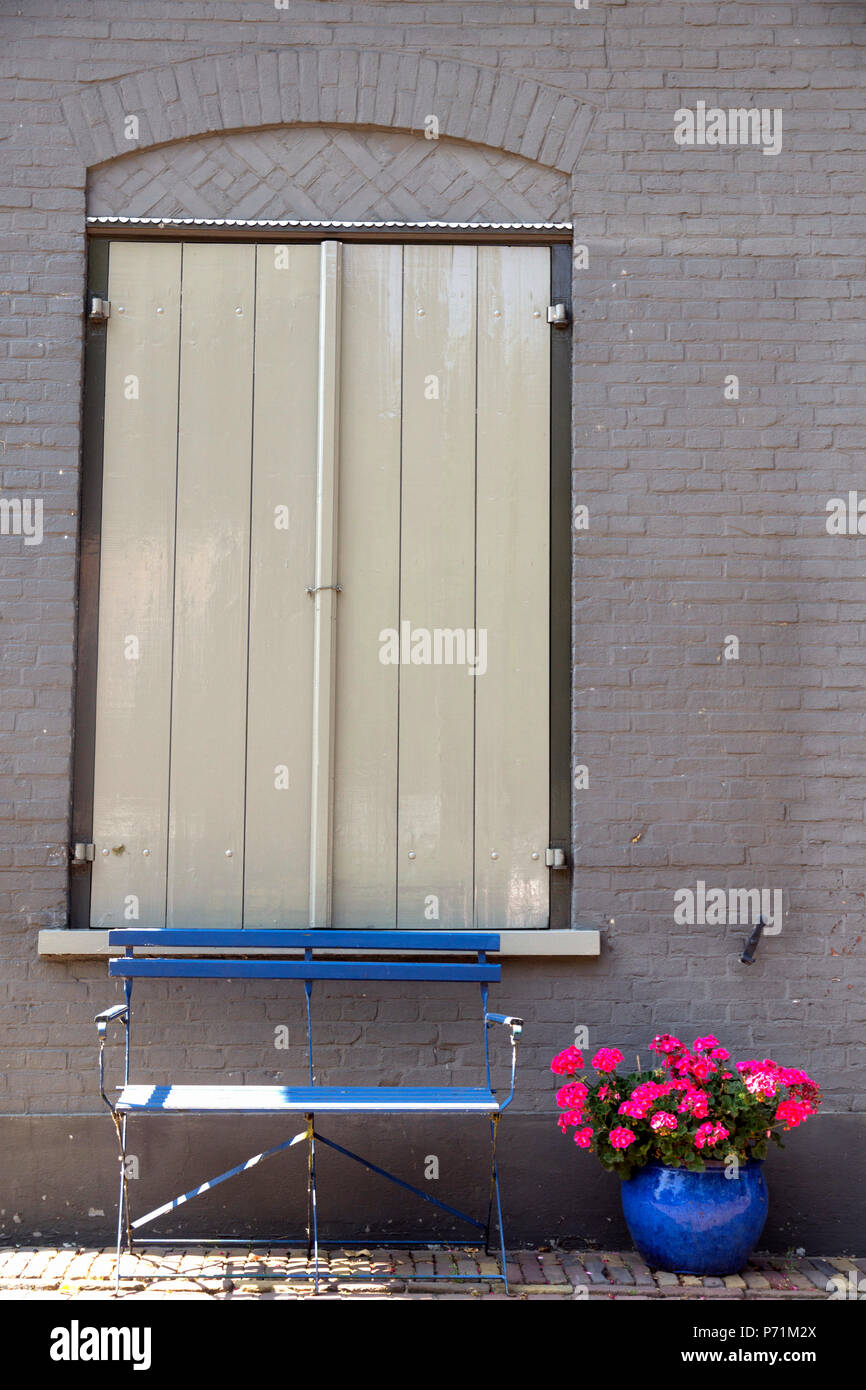 Facade with bench and flowers Stock Photo - Alamy