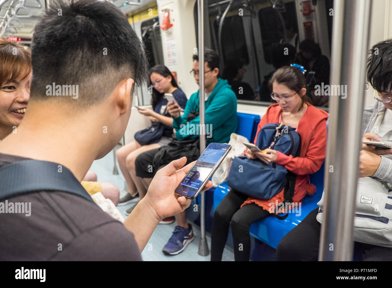 Using,mobile,phone,cell,phones,addiction,on,MRT,subway,train,rail ...