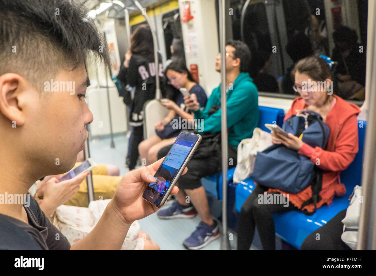 Using,mobile,phone,cell,phones,addiction,on,MRT,subway,train,rail ...