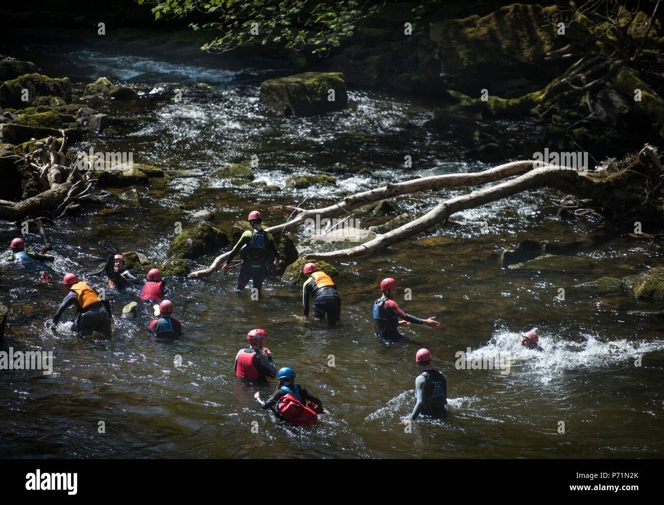 Youngsters gorge walking with an instructor from Adventure Wales on the ...