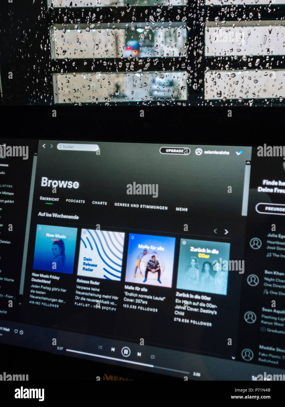 Computer screen in front of a window stained by raindrops Stock Photo ...