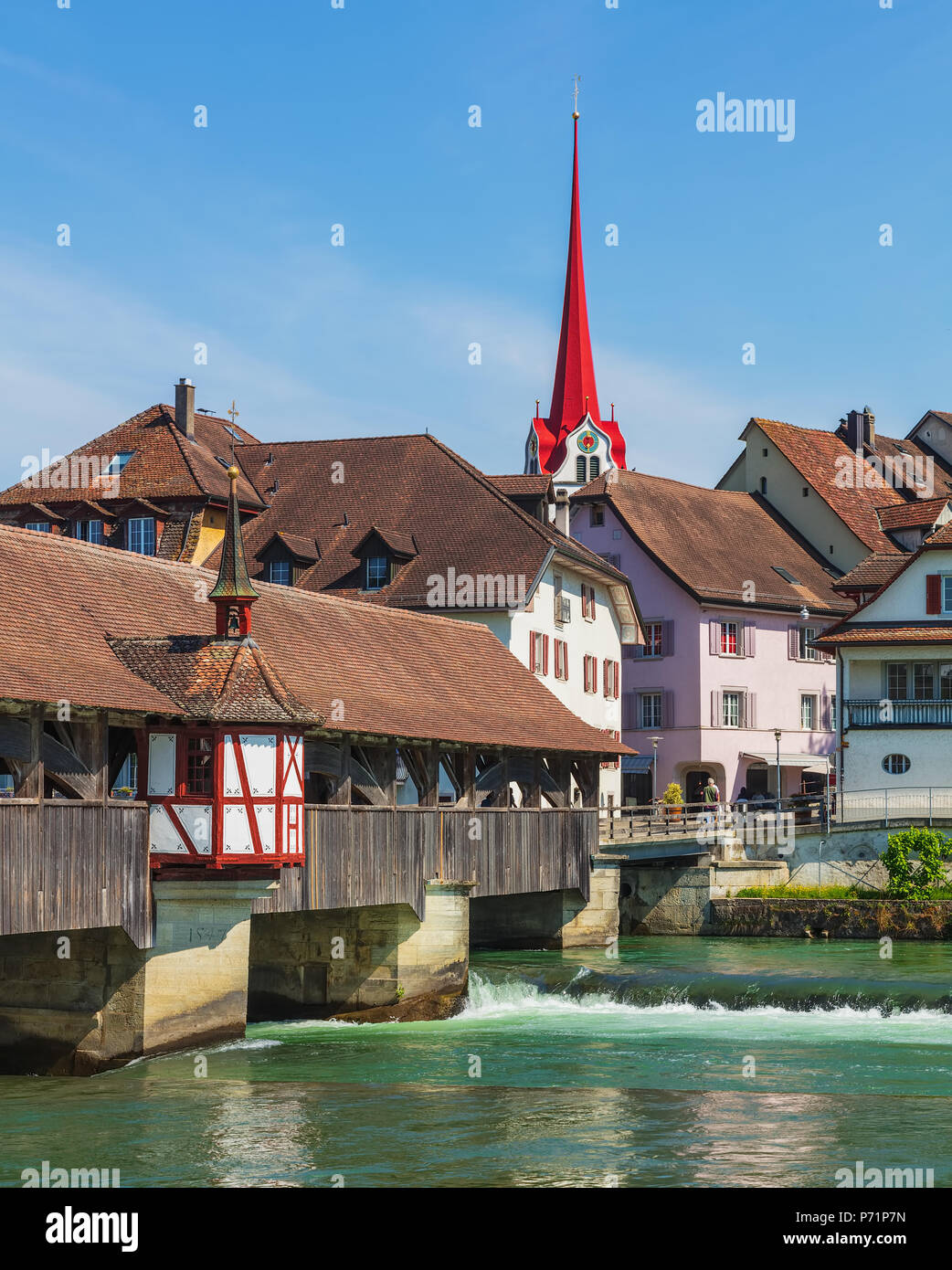 Medieval covered bridge over the Reuss river, buildings of the historic ...