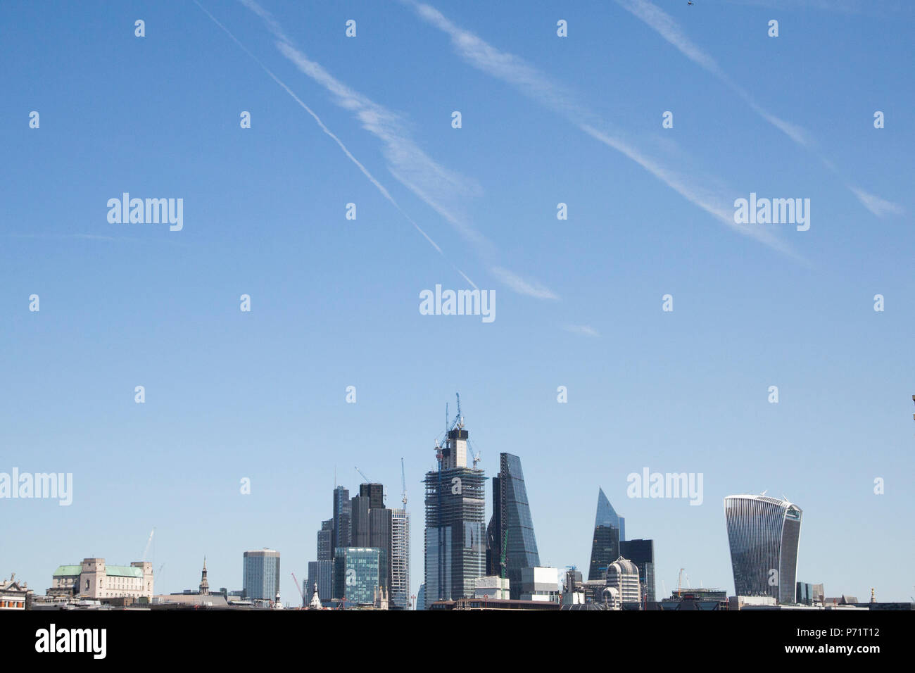 Blue Skyline with Cloud and flight trails with the Bak area of London ...
