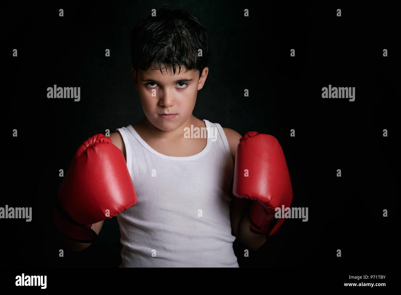 little boy with boxing gloves on black background Stock Photo - Alamy