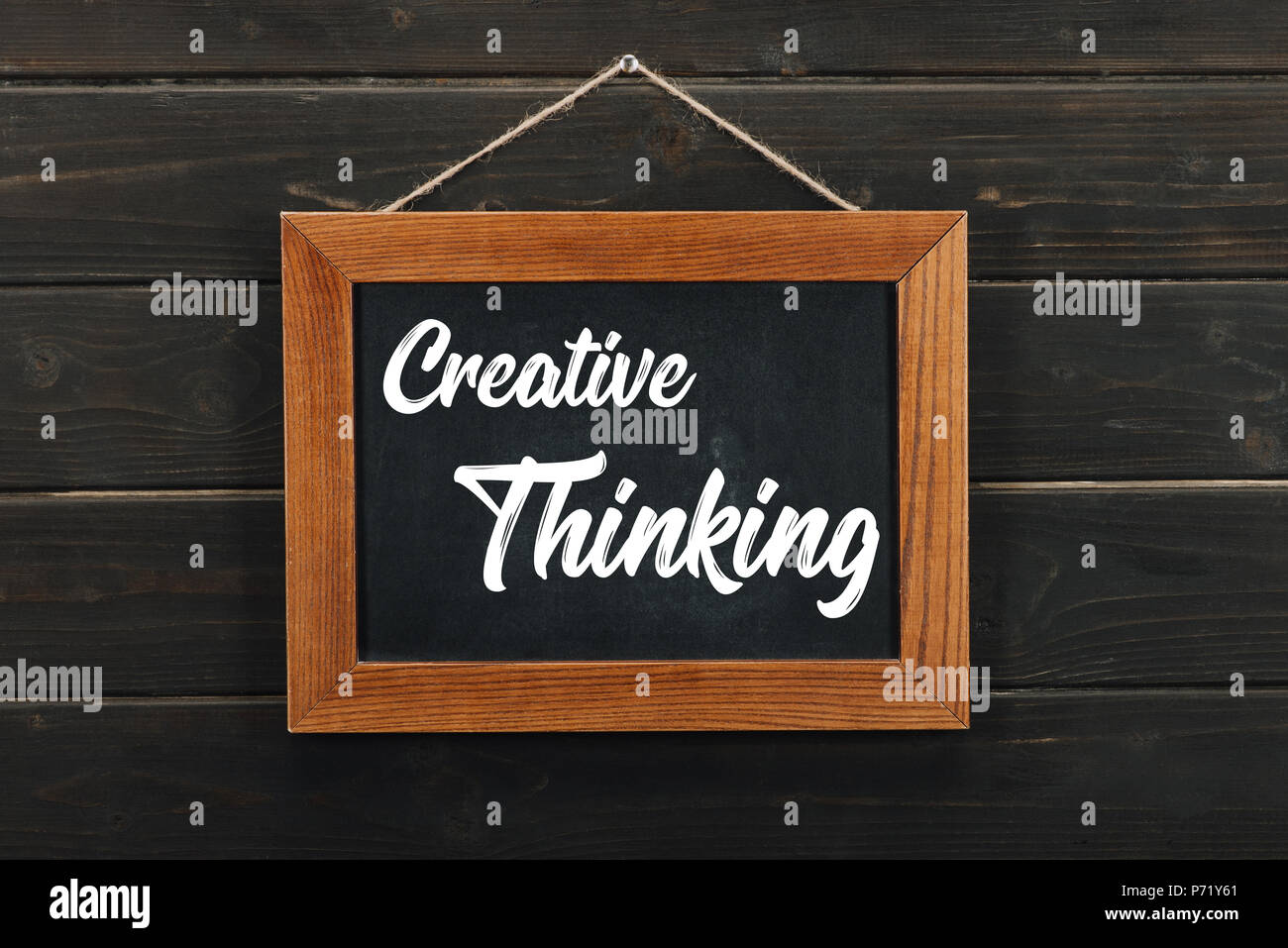 Board with lettering creative thinking hanging on wooden wall Stock ...