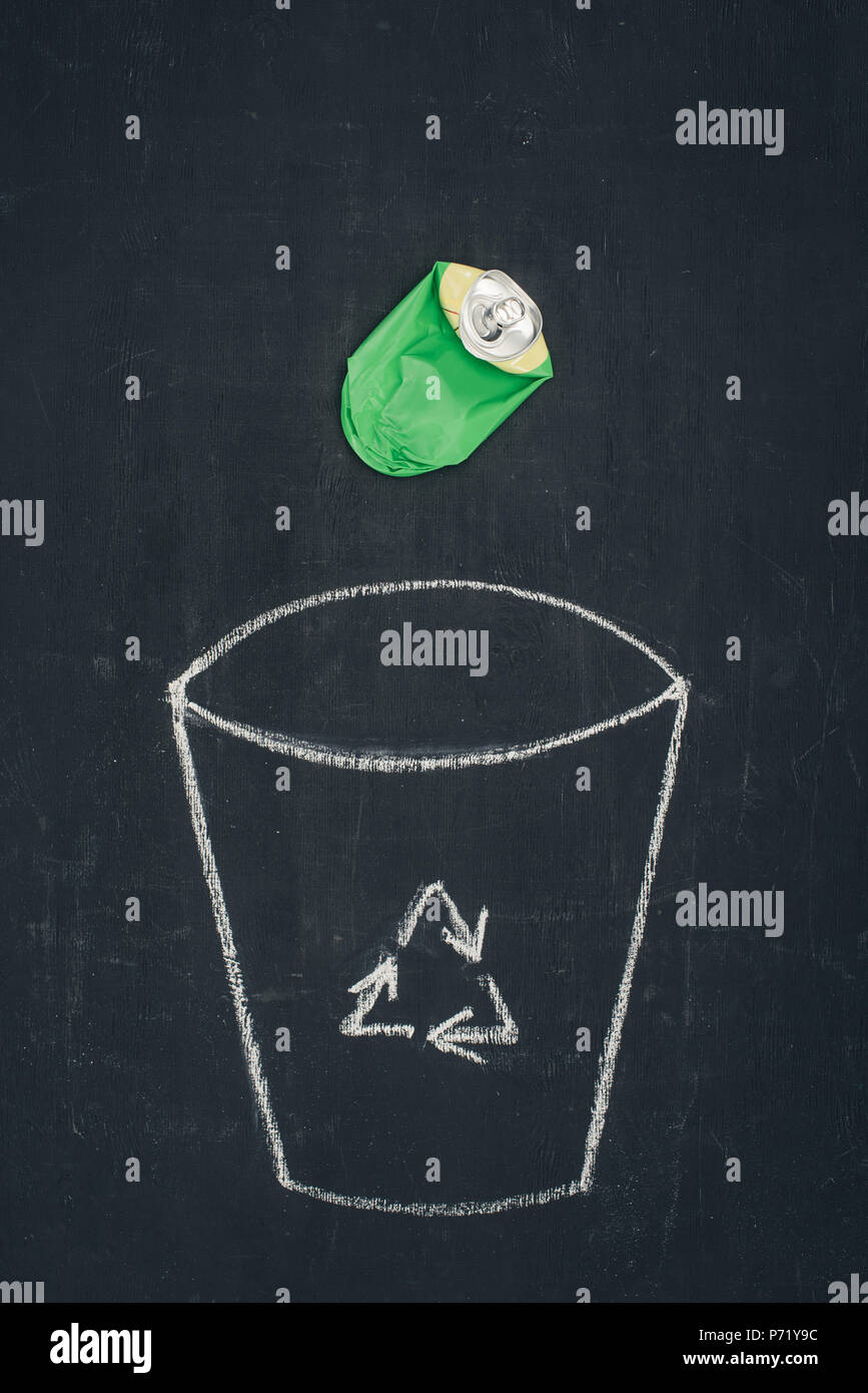 metal can falling into drawn trash bin with recycle sign on chalkboard ...
