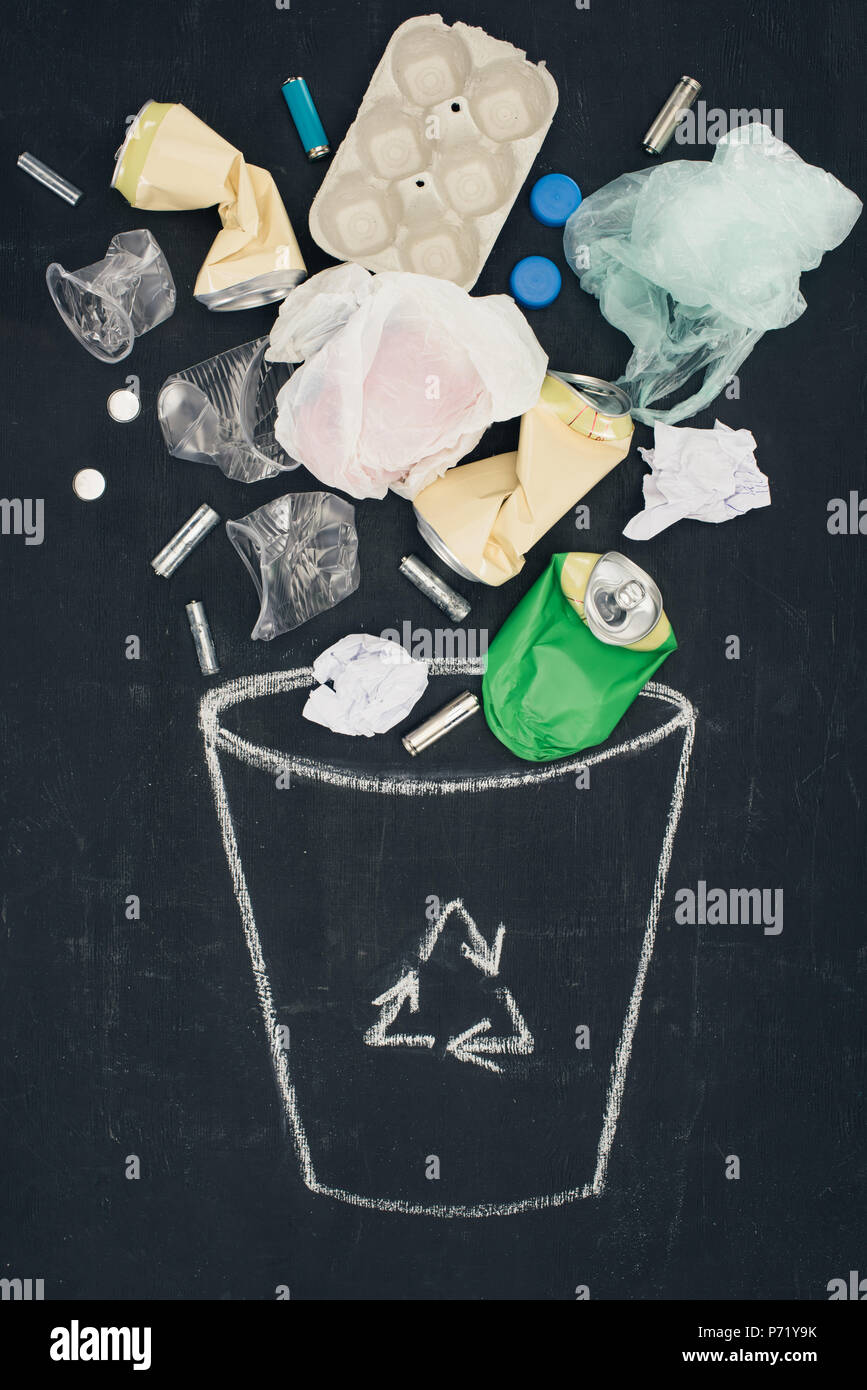 various types of trash falling into drawn trash bin with recycle sign ...